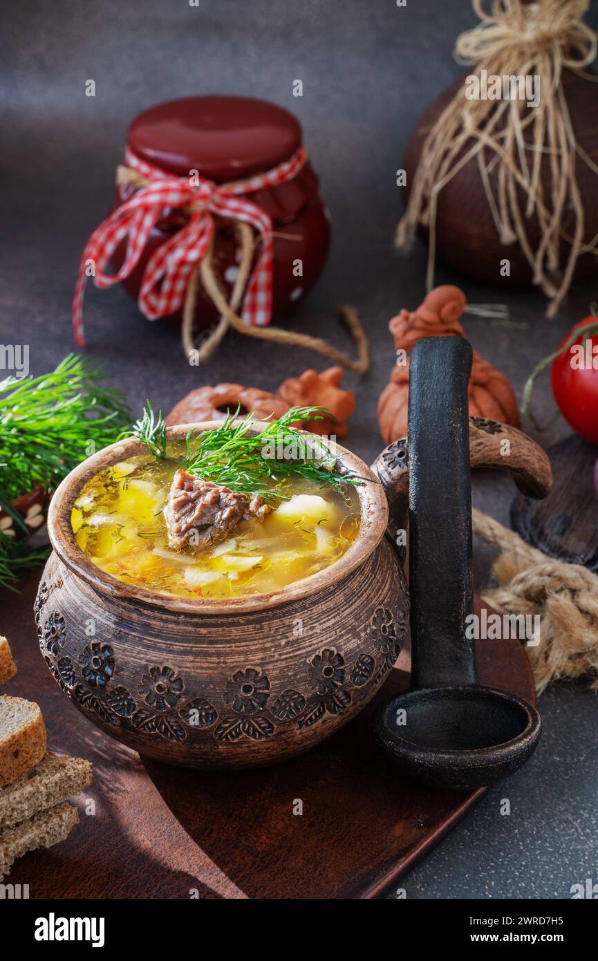 cabbage soup in a clay pot. Traditional Russian soup of sauerkraut and ...
