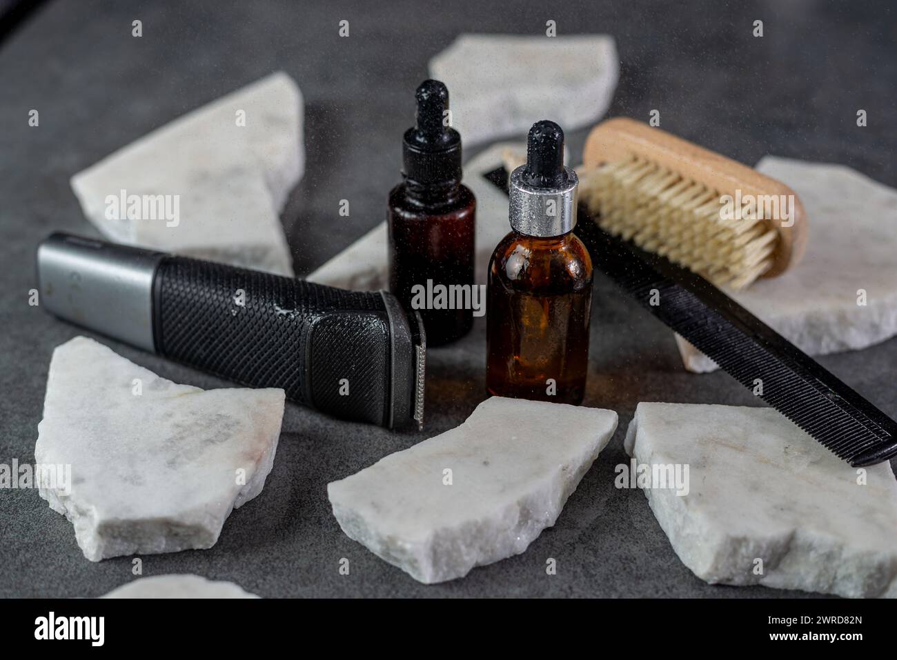 Beard oil with hair trimmer and comb Stock Photo - Alamy