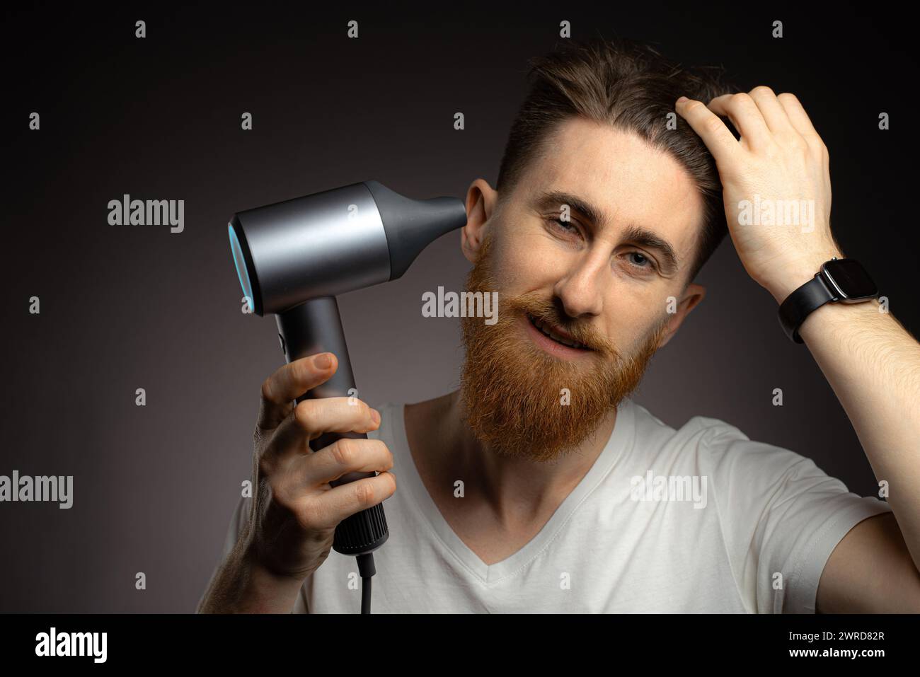 Attractive man drying hair hi-res stock photography and images - Alamy