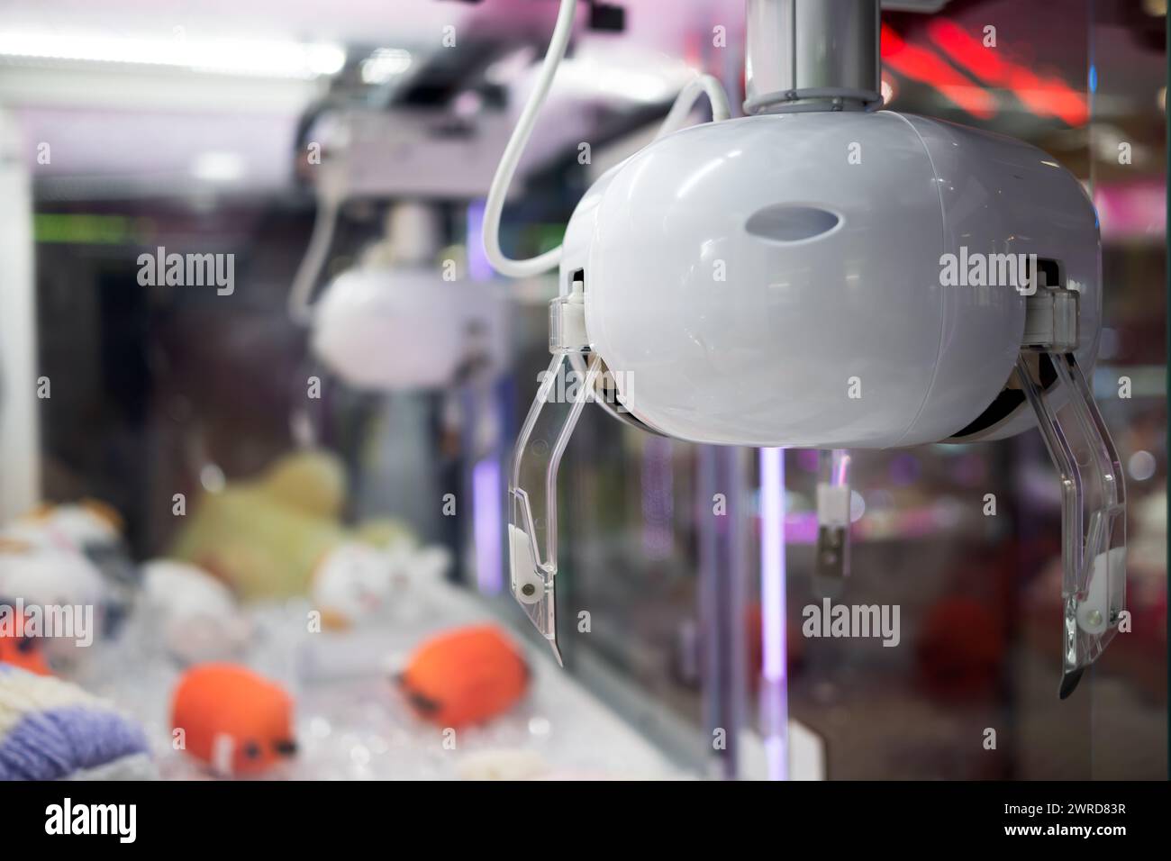 Claw machine crane game catcher at an arcade amusement game center ...