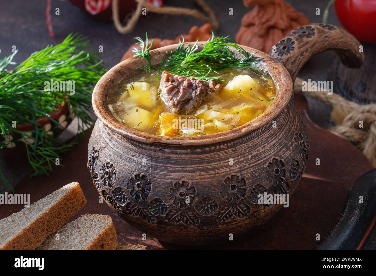 cabbage soup in a clay pot. Traditional Russian soup of sauerkraut and ...