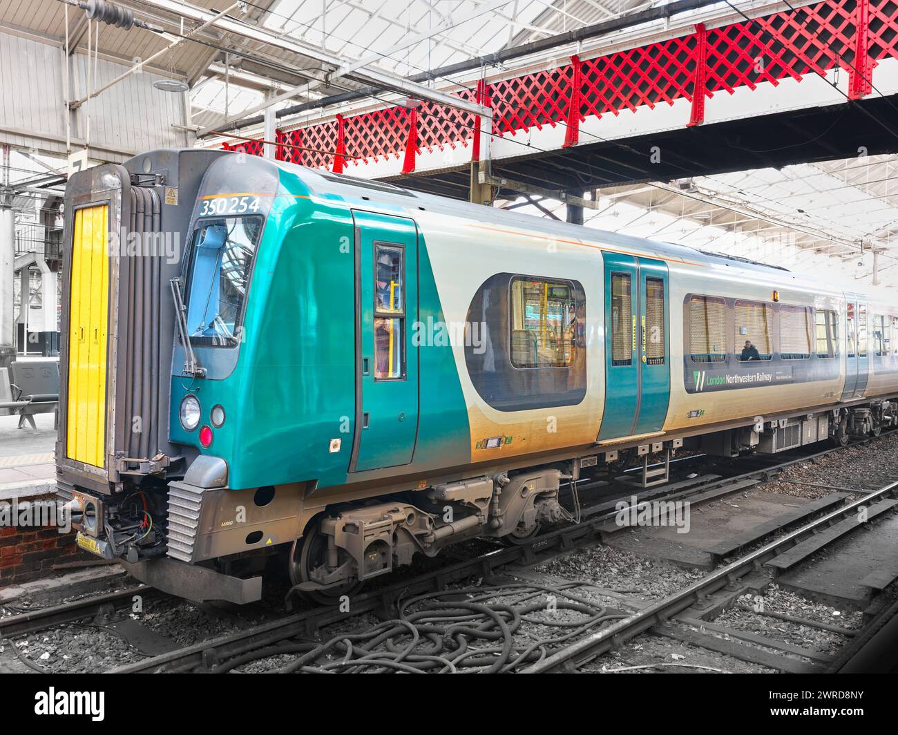 Train stationary by a platform at the railway station in Crewe, England ...