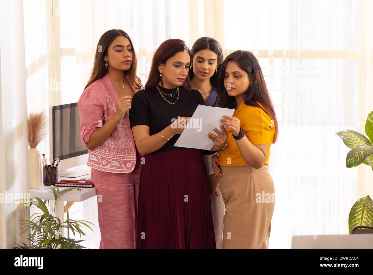 Group of business colleagues reviewing documents at meeting in modern ...