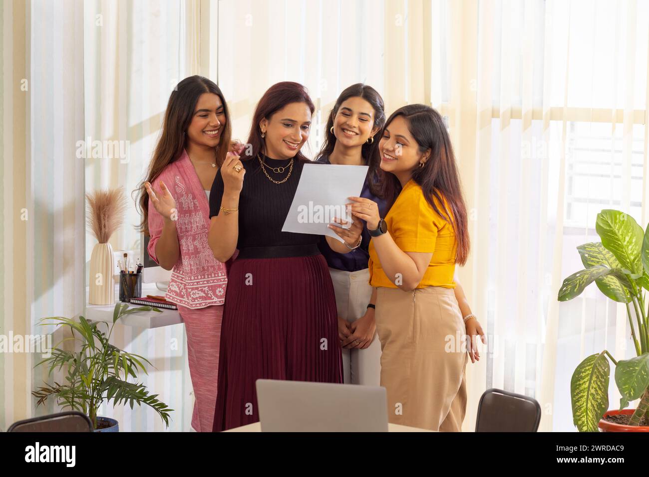 Group of business colleagues reviewing documents at meeting in modern ...