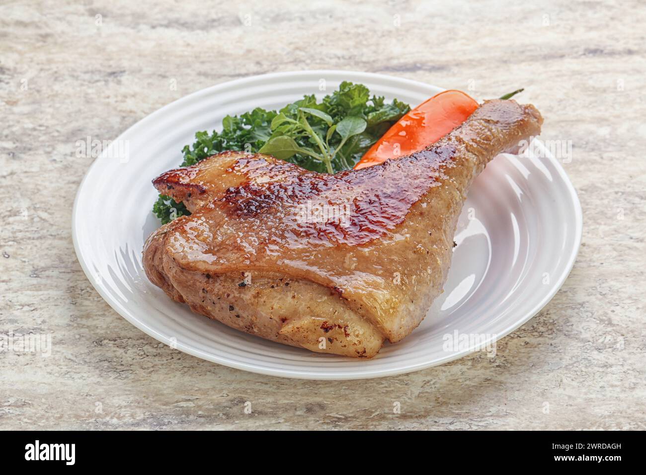Roasted duck fat leg with orange sauce Stock Photo - Alamy