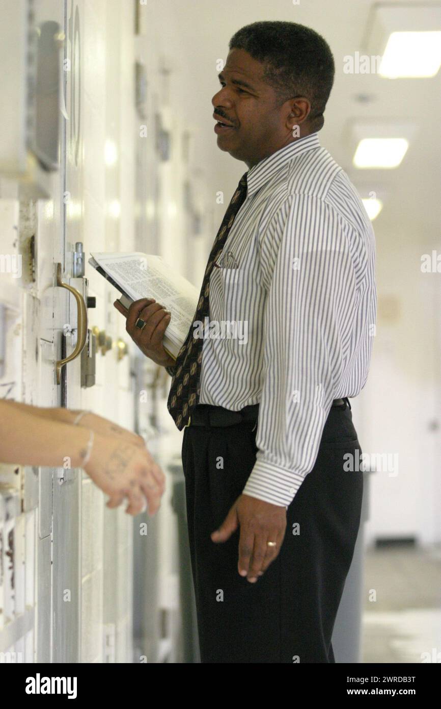 A police officer standing in front of prison cells Stock Photo - Alamy