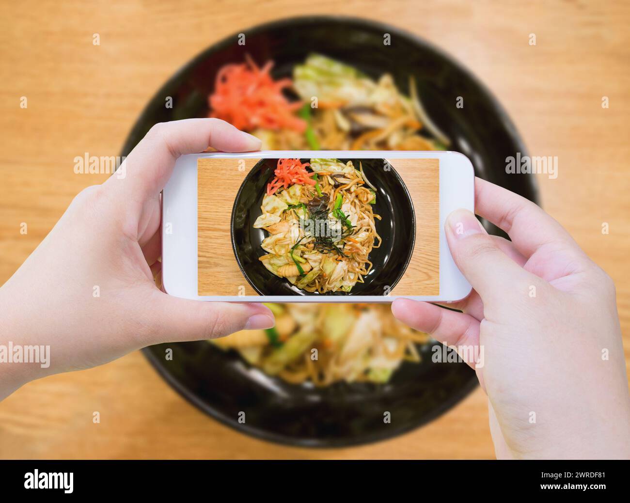 Female using mobile smart phone Taking photo of Yakisoba, japanese ...