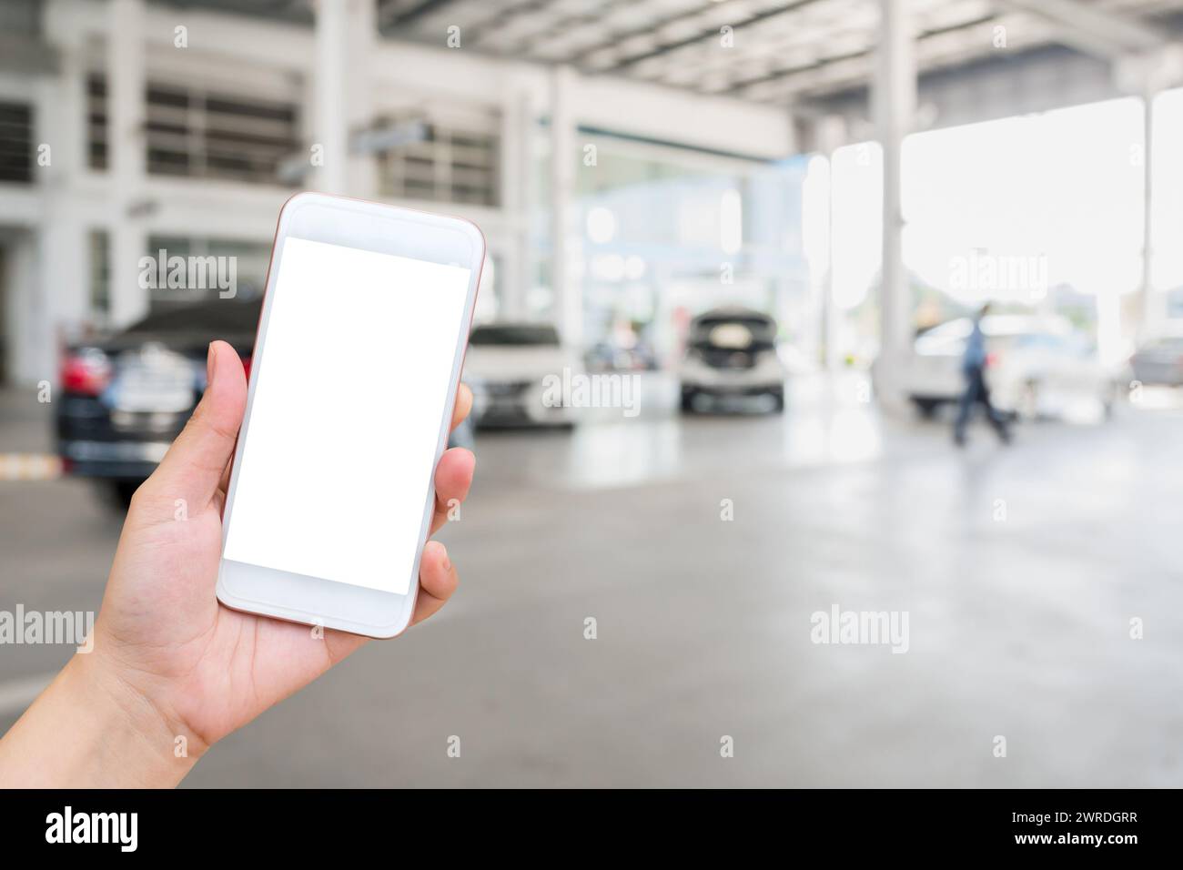 Woman using mobile smartphone with blur cars parking background Stock ...