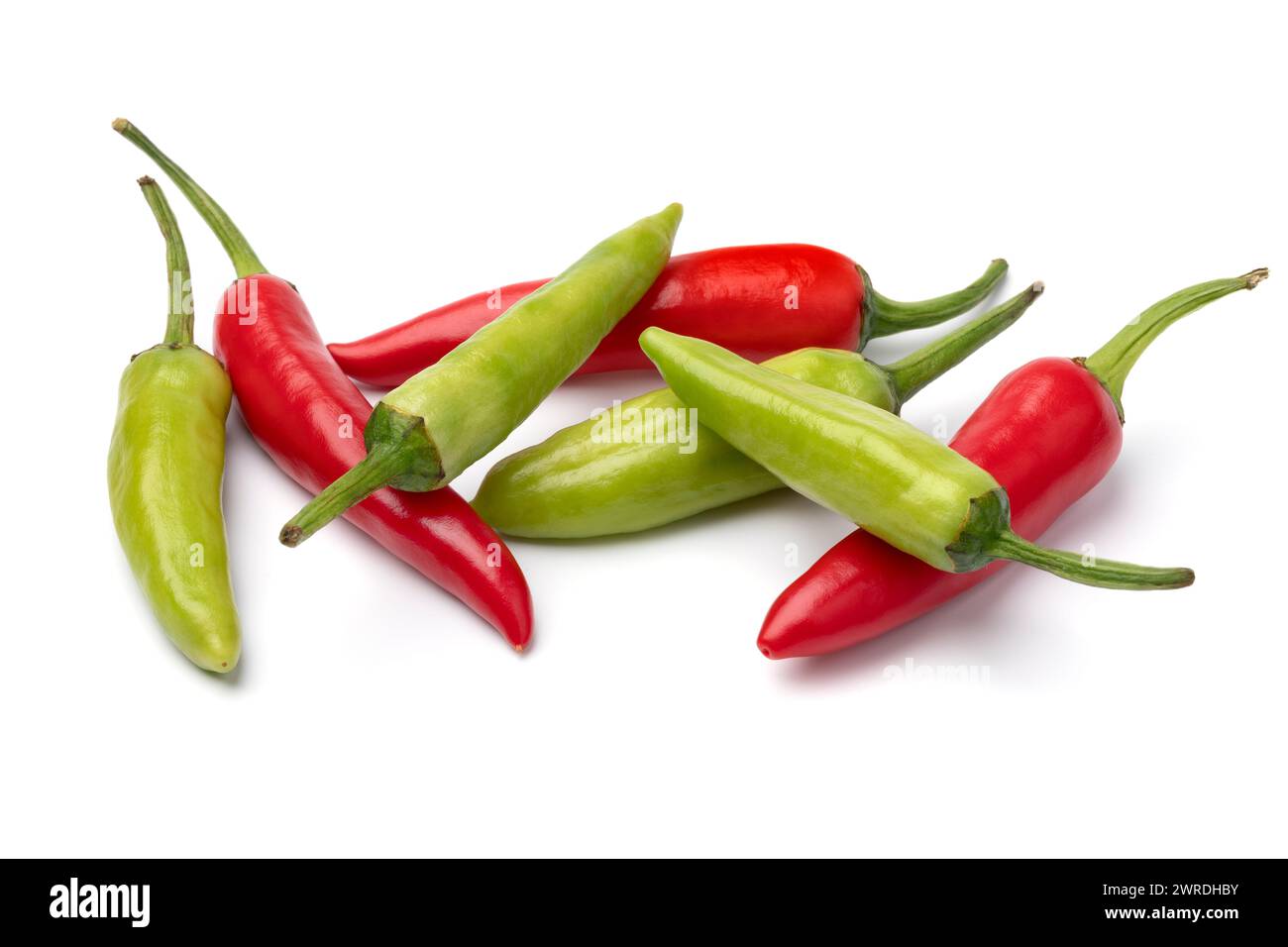 Heap of whole fresh raw green and red rawit peppers close up isolated ...
