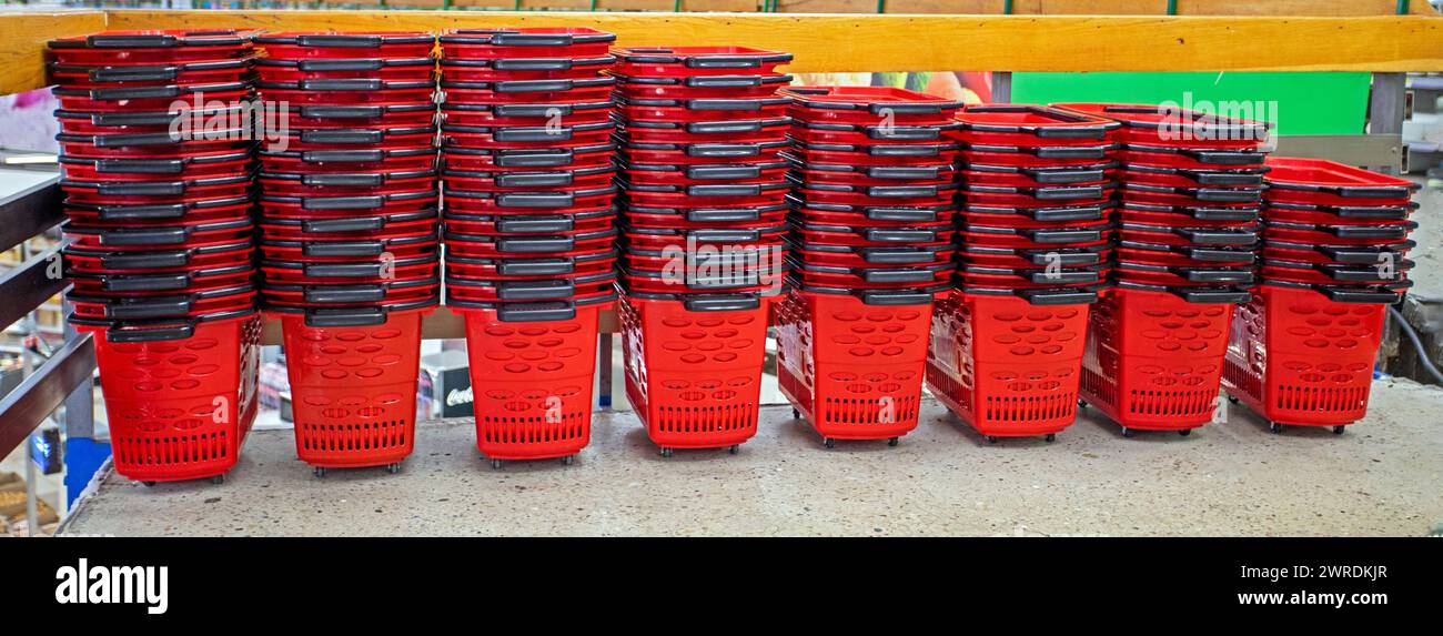 red carts for groceries and other goods are stacked in a supermarket ...