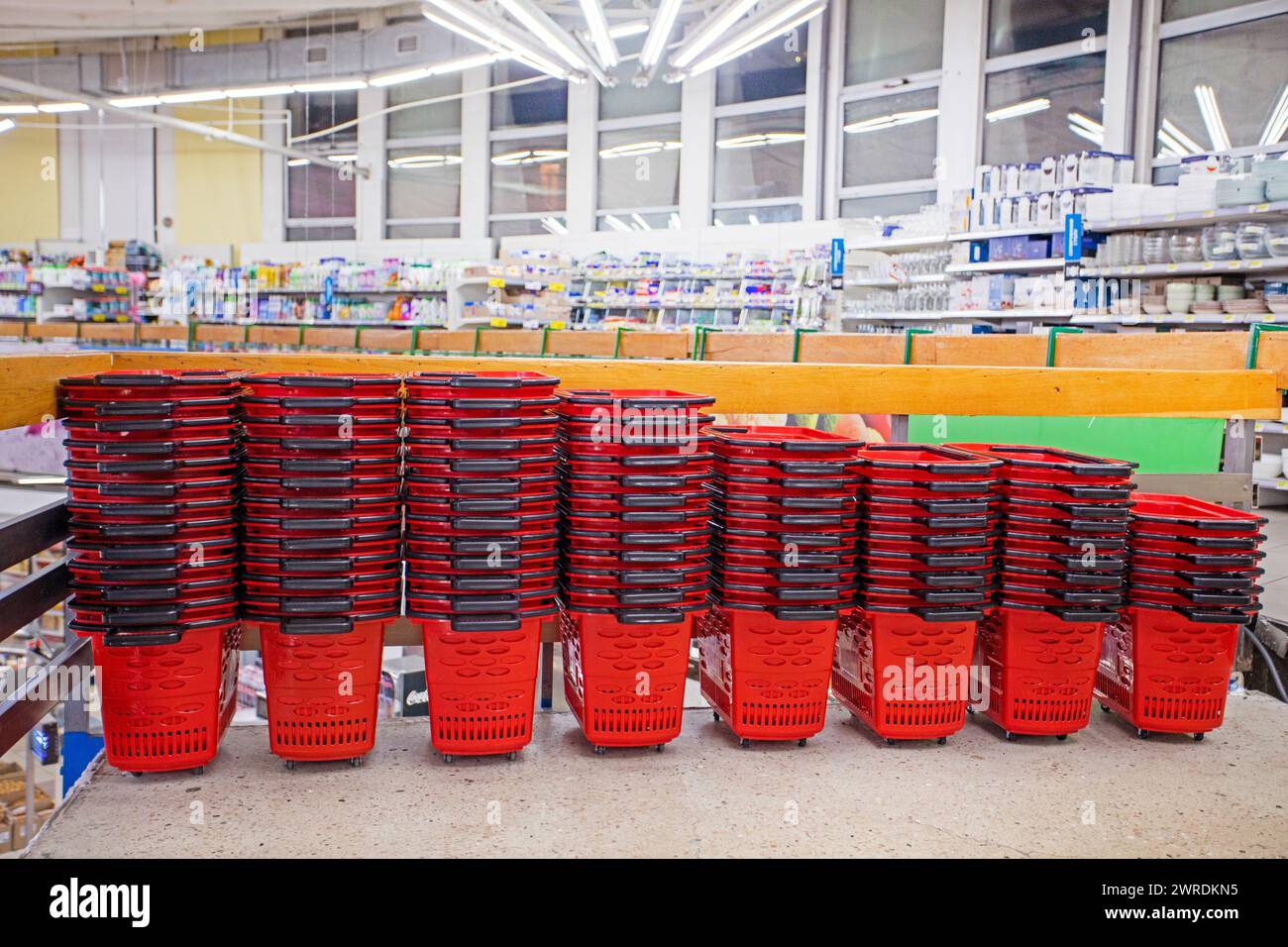 red carts for groceries and other goods are stacked in a supermarket ...