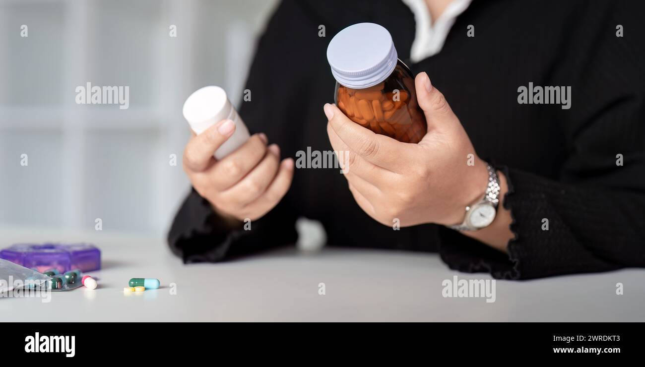 Close up woman holding pill in hand with water. Female take tablet from ...
