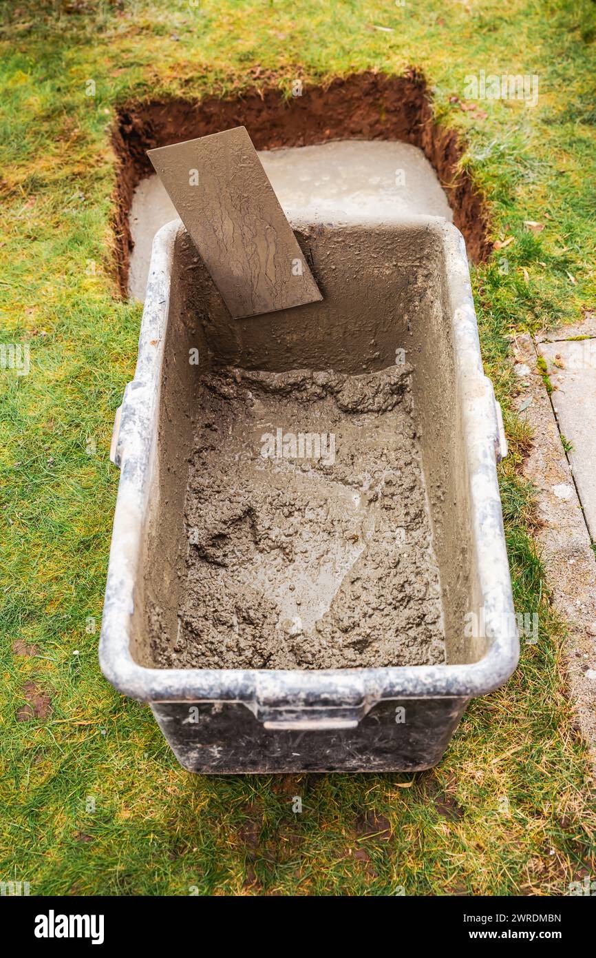 Mixed concrete in a bucket, construction work in a garden Stock Photo ...