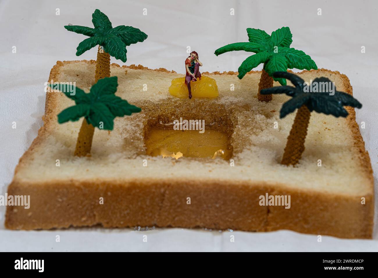 A slice of bread with honey and miniature palm trees on top Stock Photo ...