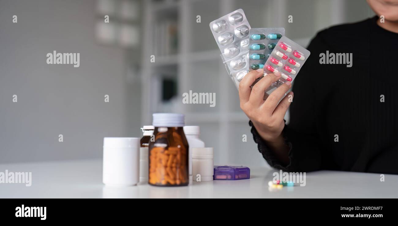 Close up woman holding pill in hand with water. Female take tablet from ...