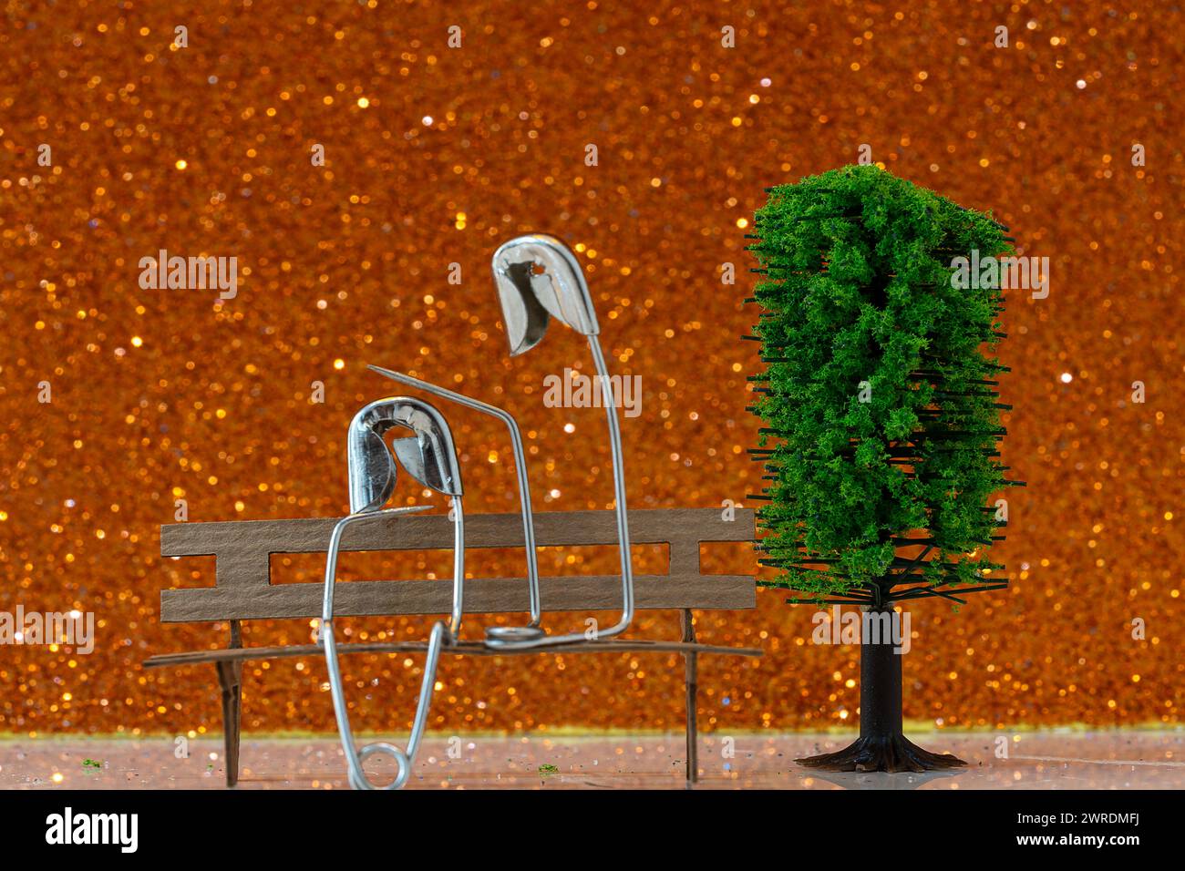 The safety pins on a small bench with a red glitter background Stock ...