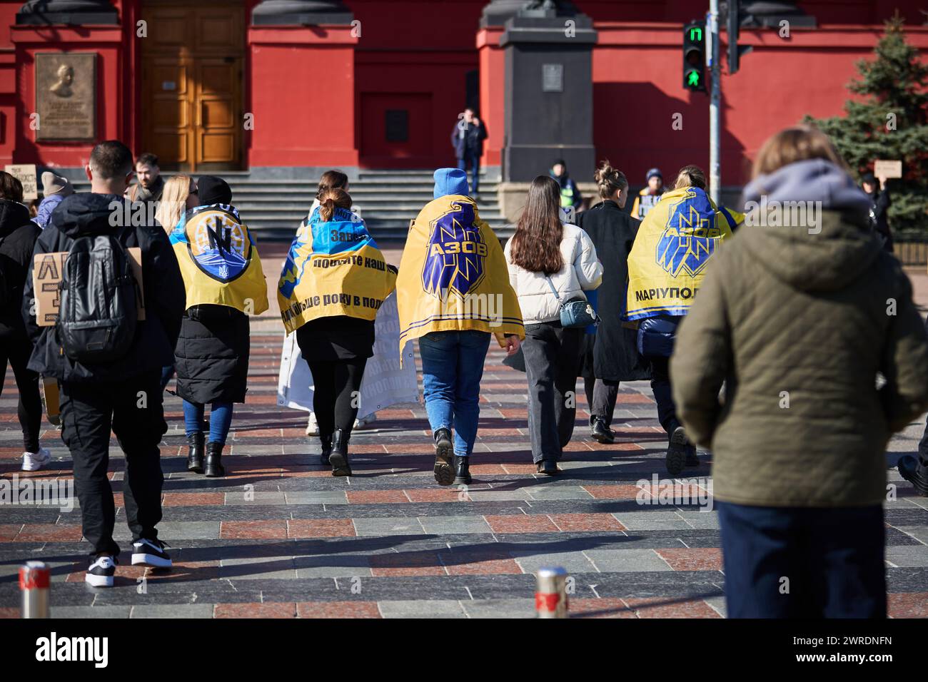 Ukrainian activists wearing flags of Azov brigade on shoulders walk ...