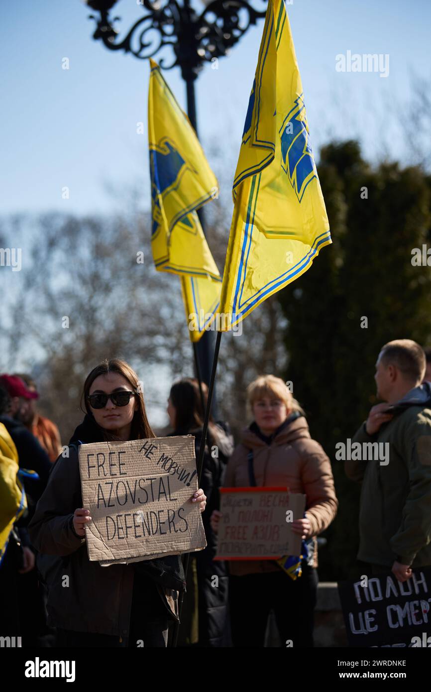Ukrainian activists hold banner "Free Azovstal Defenders" and flags of ...