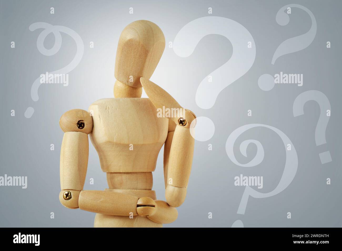 Wooden mannequin in thinking pose with quesion marks - Concept of ...