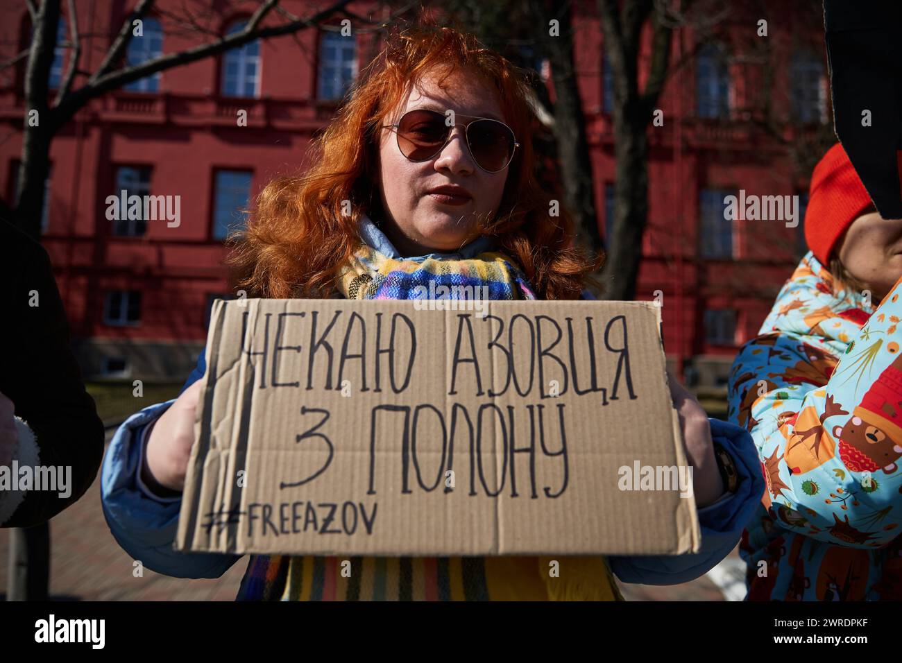 Ukrainian woman posing with a banner "I Am Waiting For Azov Fighter ...