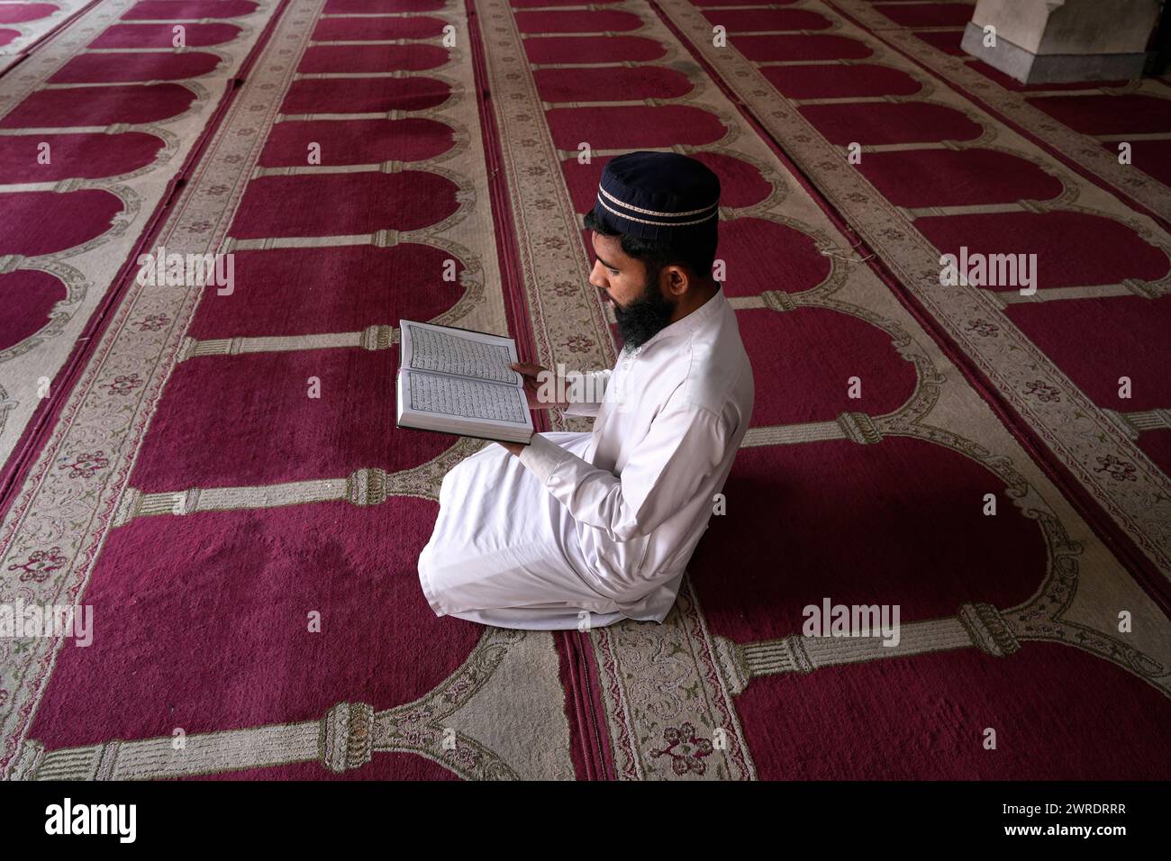 A Muslim recite from the holy book Quran during the Muslim holy fasting ...