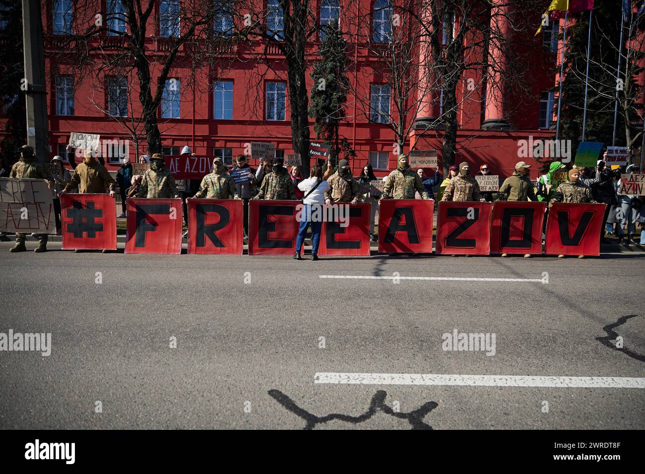 Ukrainian soldiers show a banner "Free Azov" on a public demonstration ...