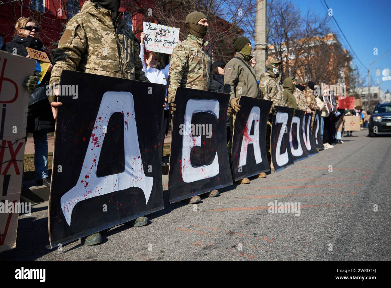 Ukrainian soldiers show a banner "Where Is Azov?" on a public ...
