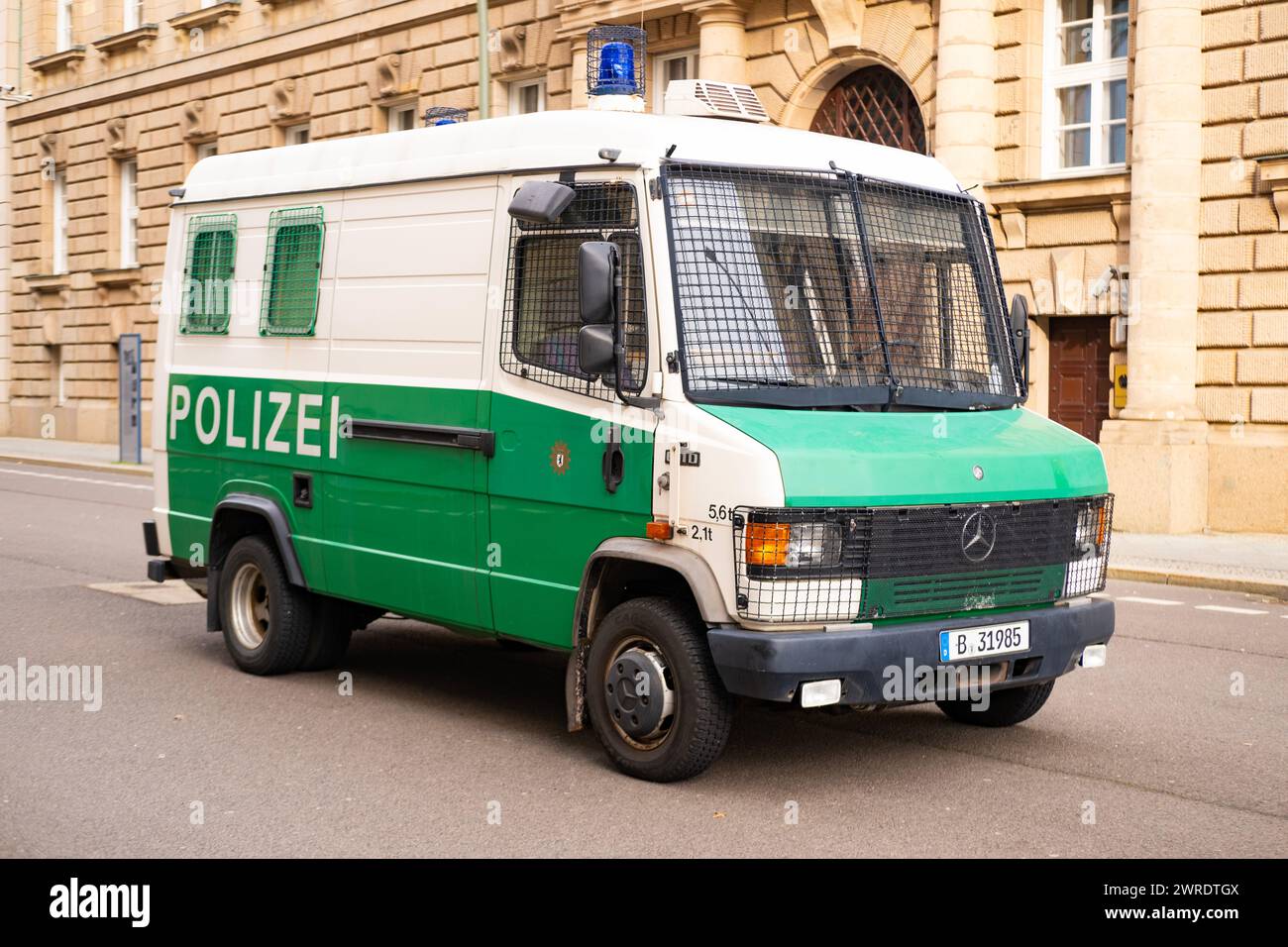 white and green police bus parked on street in Berlin, symbol law and ...