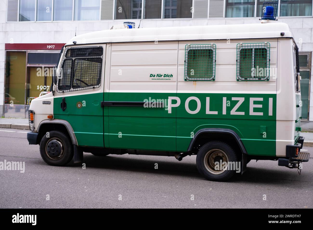 white and green police bus parked on street in Berlin, symbol law and ...