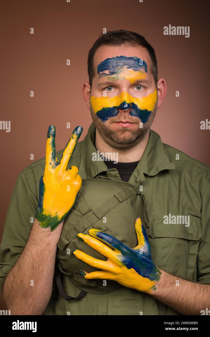 Man expressing respect to Ukraine with national colors on face Stock ...