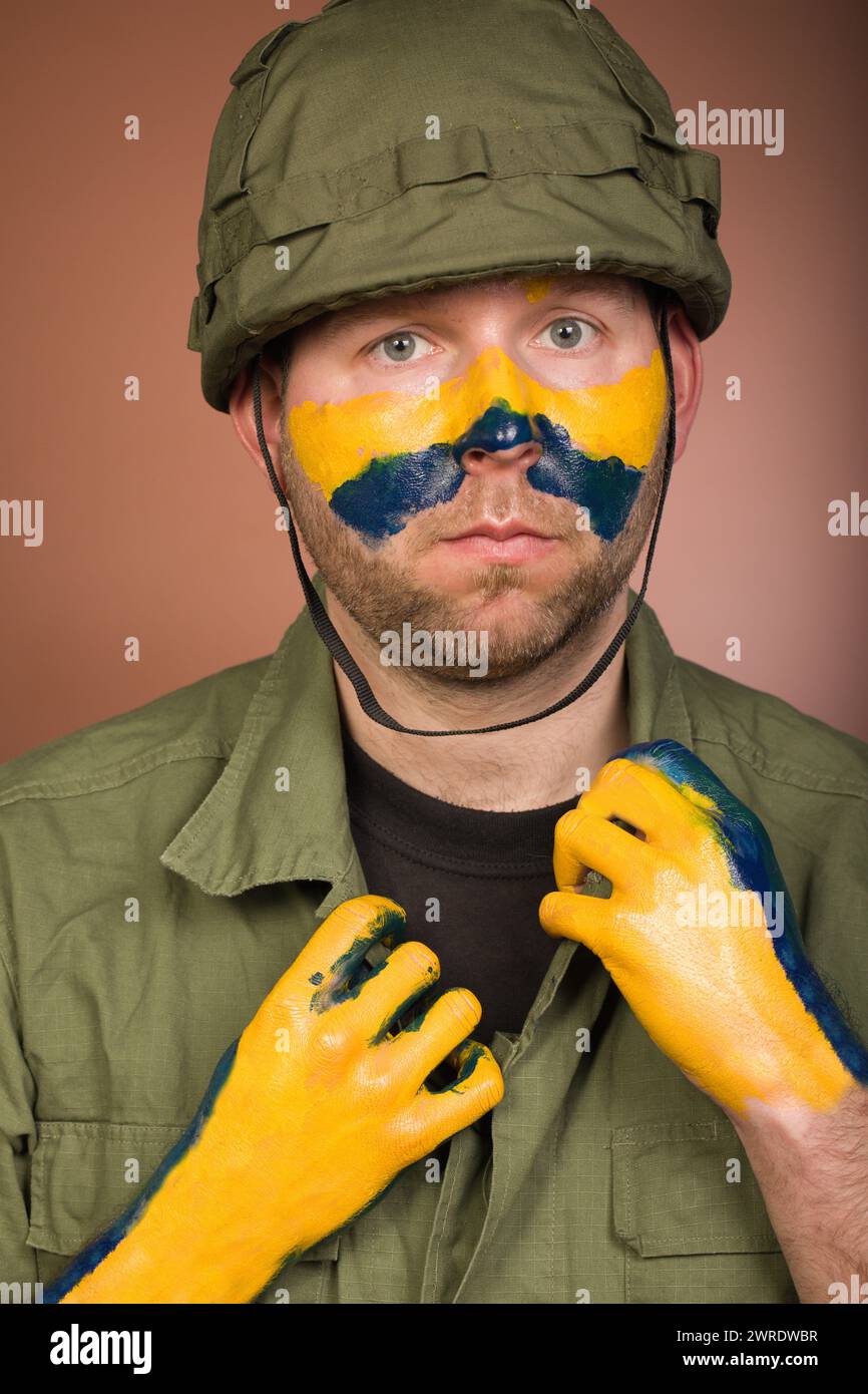 Man expressing respect to Ukraine with national colors on face Stock ...