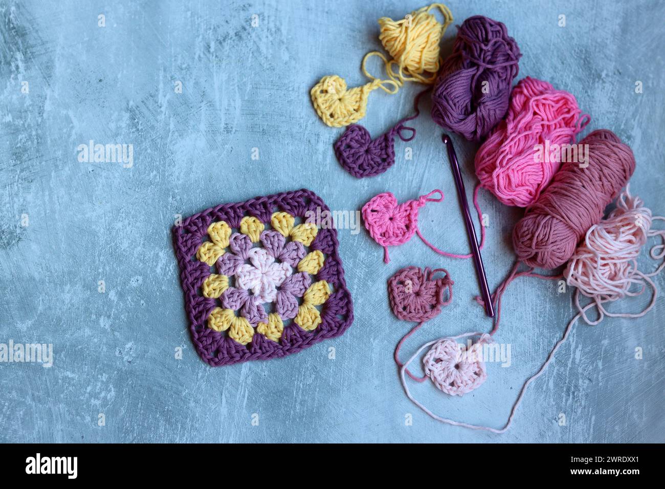 Handmade crocheting. Crocheted pink, purple, yellow and white granny ...