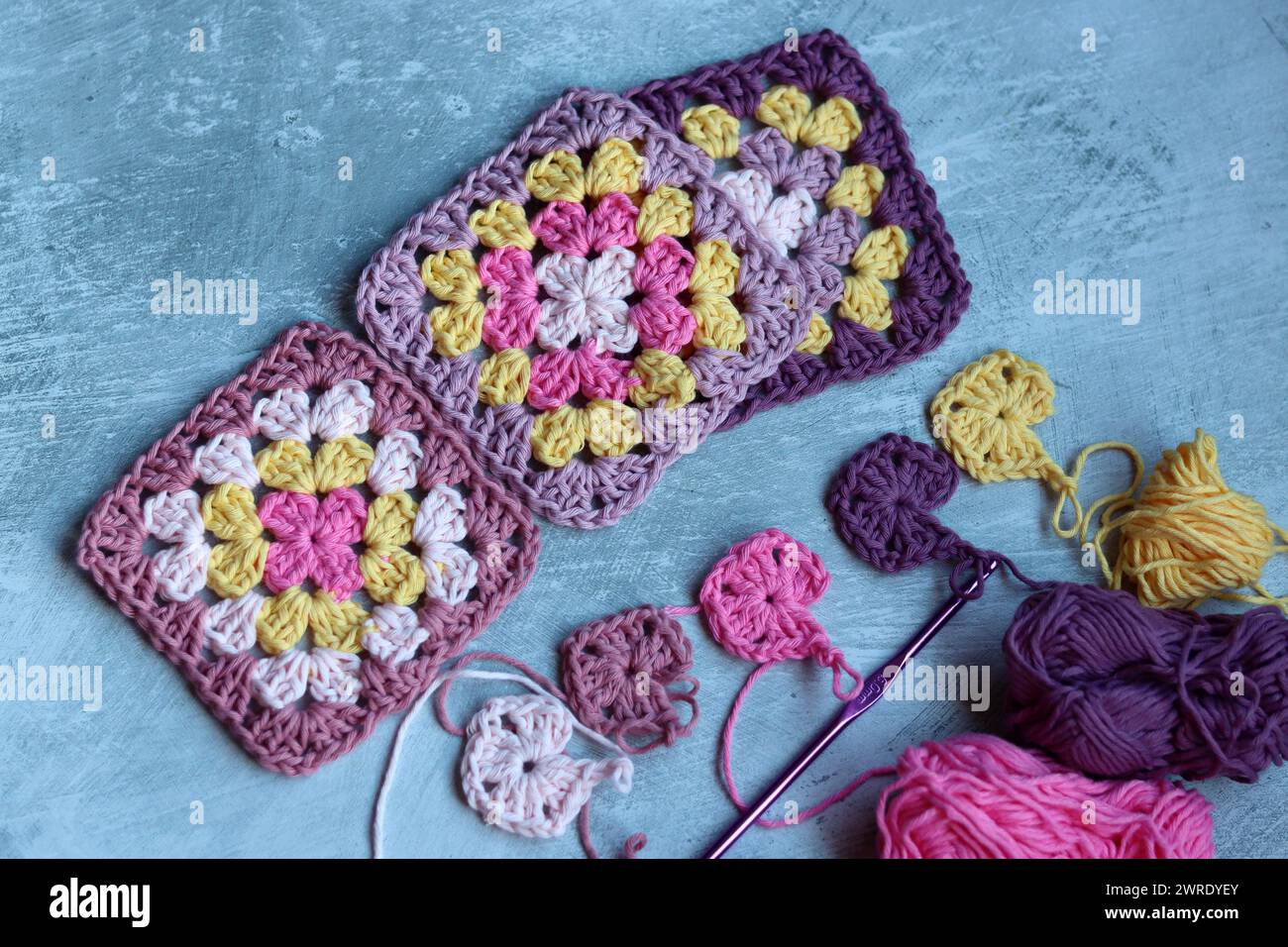 Handmade crocheting. Crocheted pink, purple, yellow and white granny ...