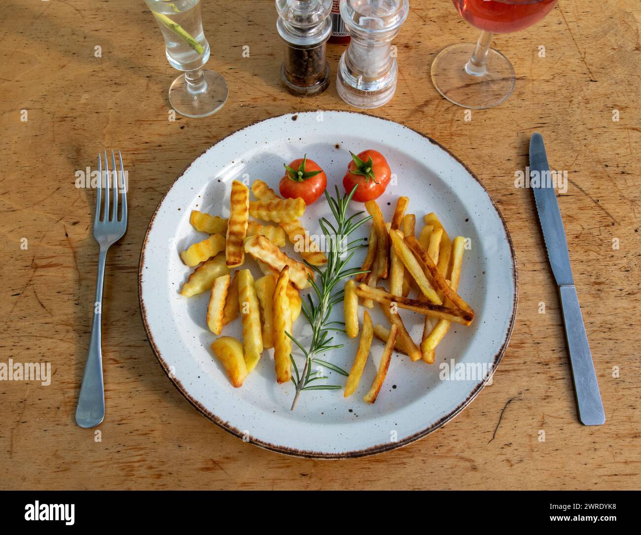An elegantly simple dinner place setting with a main course of chips ...