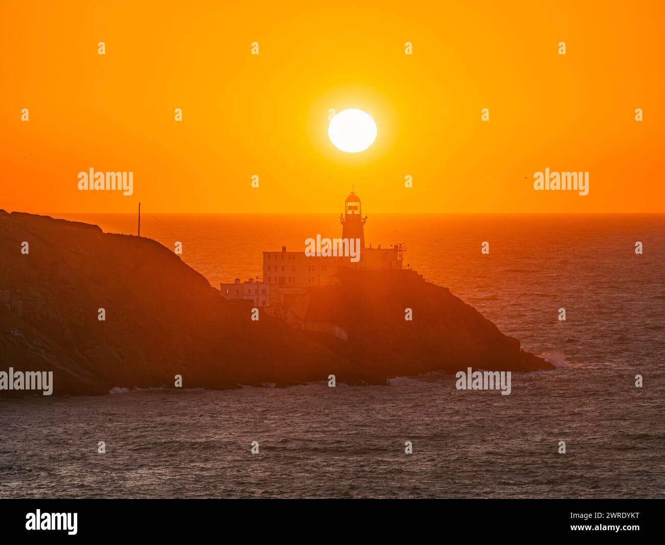 Sunrise over the Baily Lighthouse and the Howth Cliff Walk Stock Photo ...