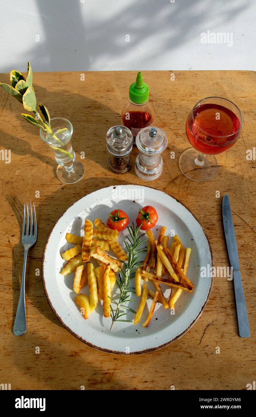 An elegantly simple dinner place setting with a main course of chips ...