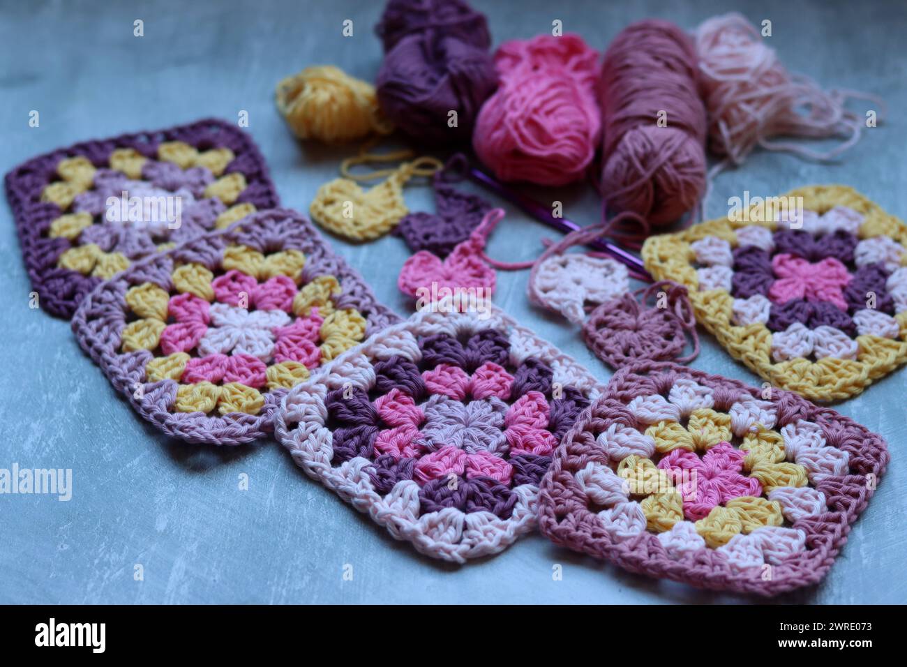 Handmade crocheted zigzag ornaments on grey background with copy space ...