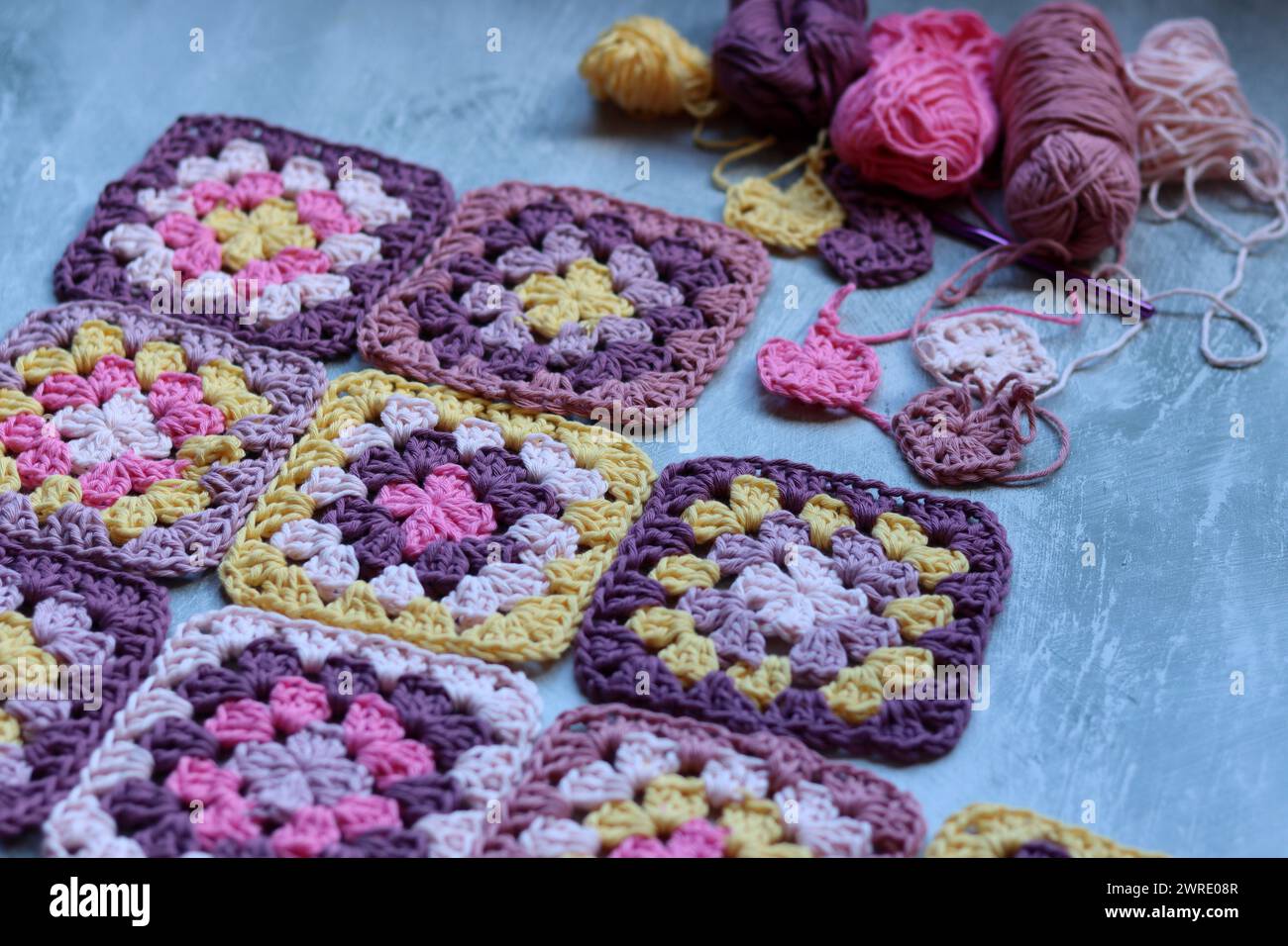 Handmade crocheting. Crocheted pink, purple, yellow and white granny ...