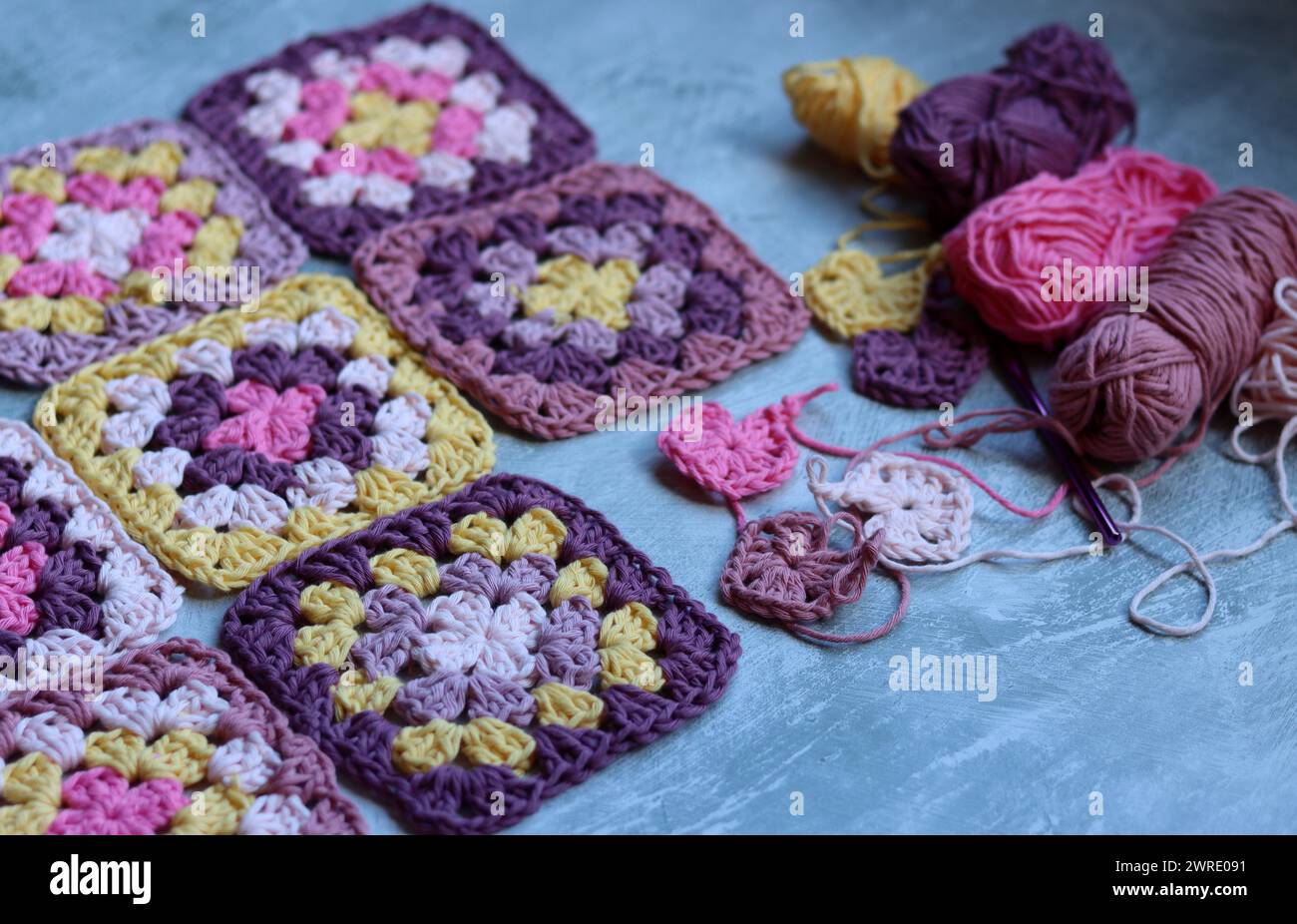Handmade crocheting. Crocheted pink, purple, yellow and white granny ...