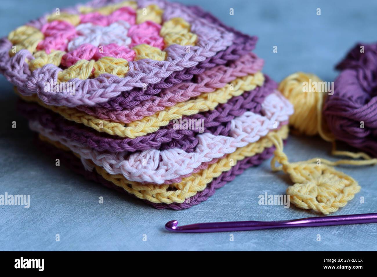 Handmade crocheting. Crocheted pink, purple, yellow and white granny ...