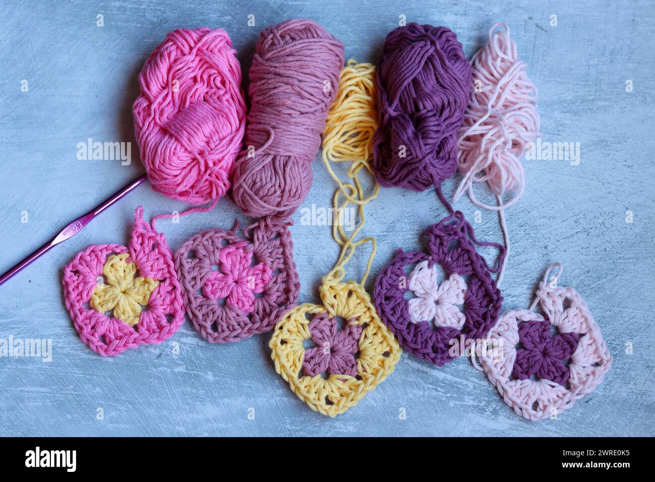 Handmade crocheting. Crocheted pink, purple, yellow and white granny ...