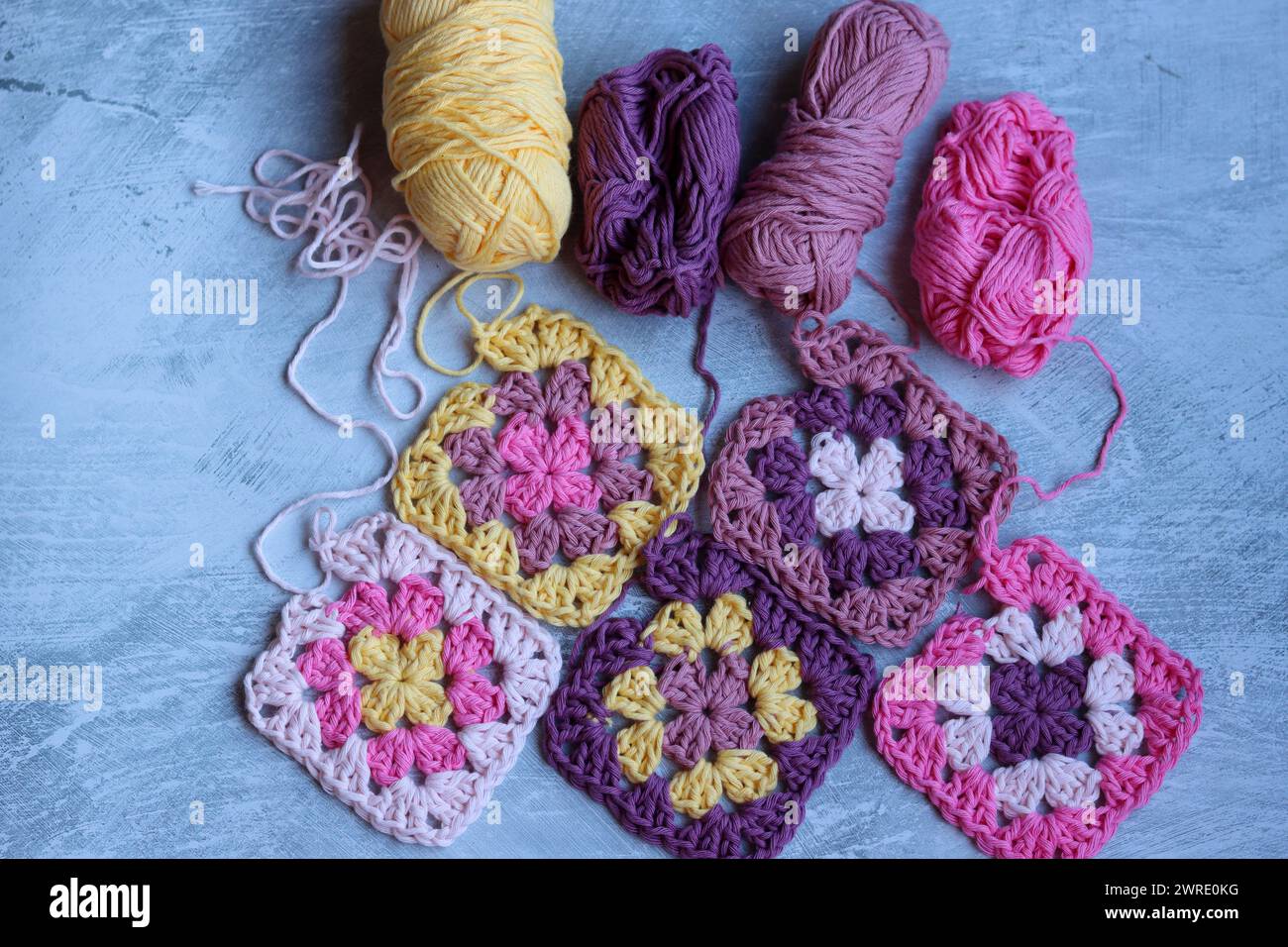 Handmade crocheting. Crocheted pink, purple, yellow and white granny ...