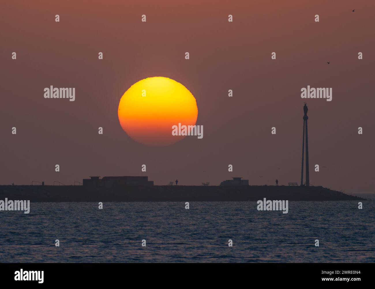 Hazy sun rising over the North Bull Wall on a mid-February morning ...