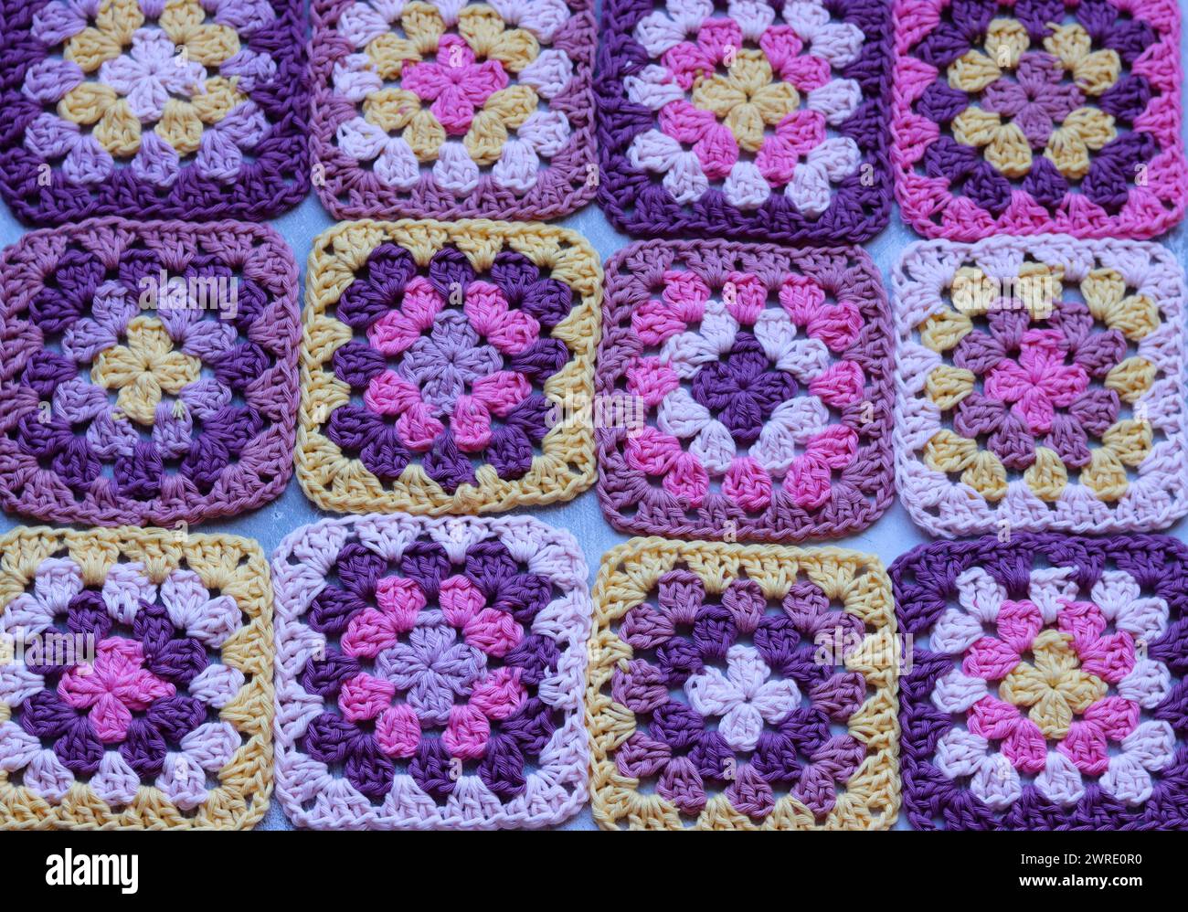 Handmade crocheting. Crocheted pink, purple, yellow and white granny ...