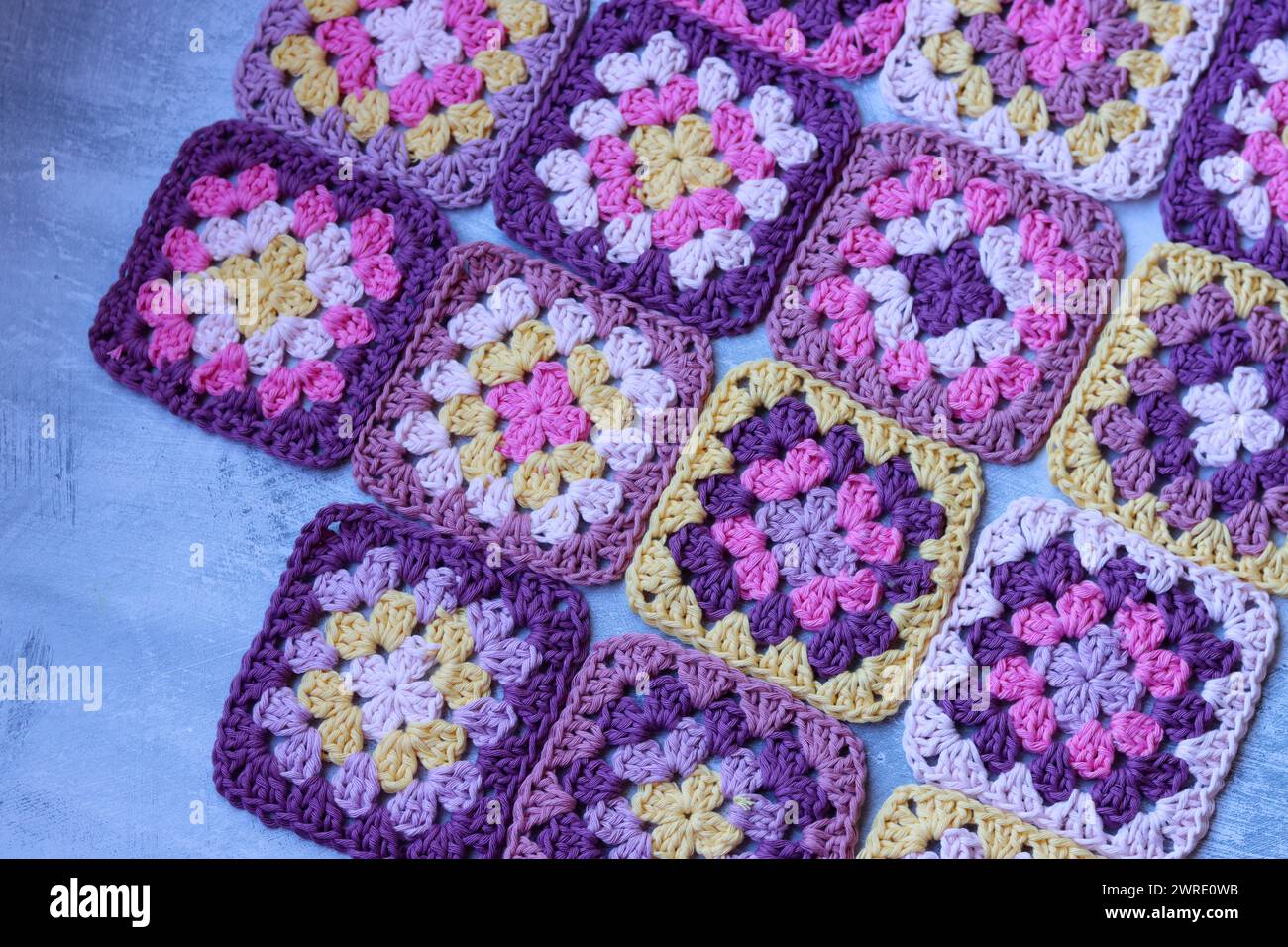 Handmade crocheted zigzag ornaments on grey background with copy space ...