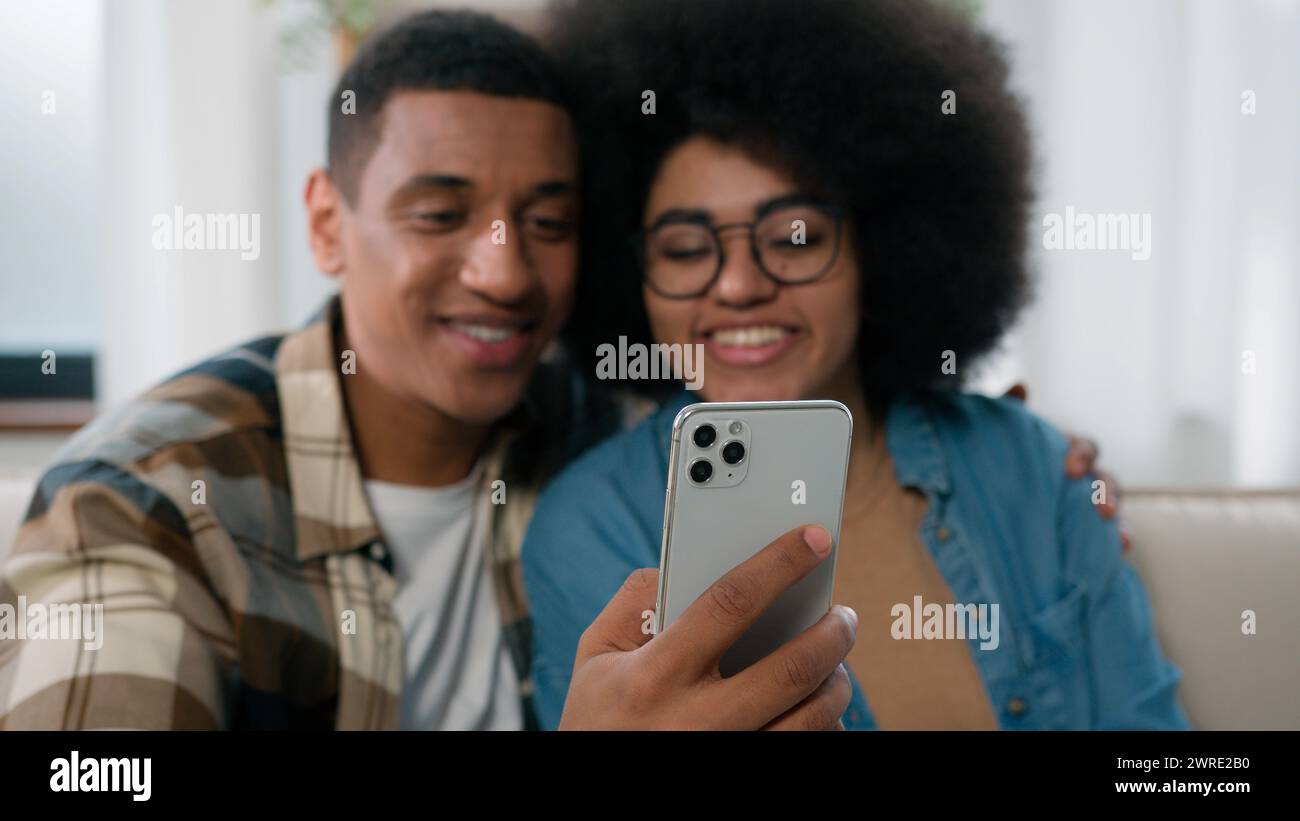 Happy smiling African American cuddling hugging ethnic family man woman ...