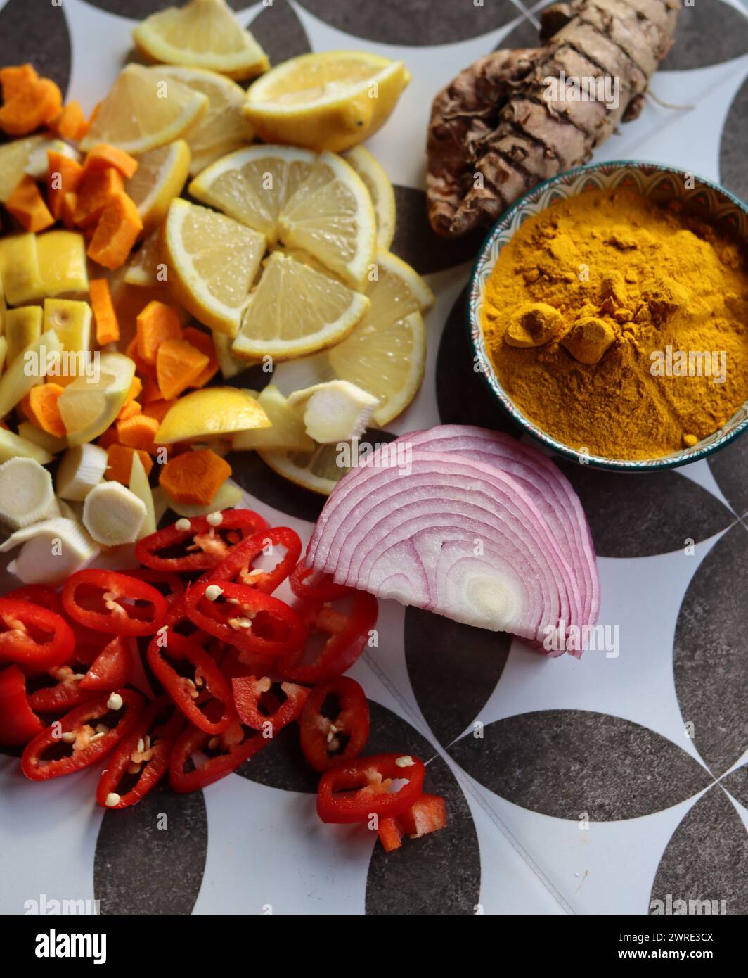 Fire cider chopped ingredients on grey tiled background. Top view photo ...