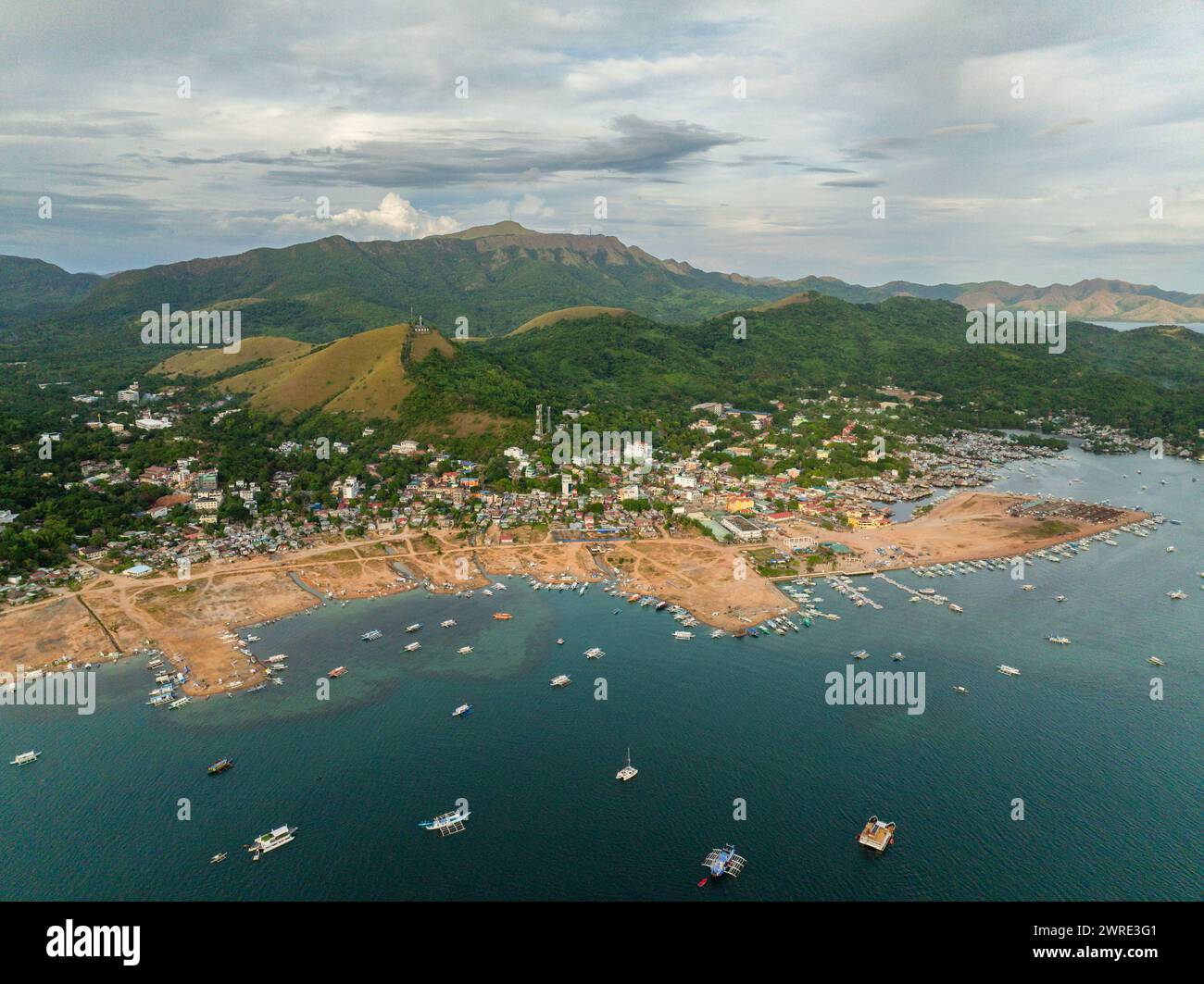 Pier with tour boats in Coron Town Proper. Mountain hills, view from ...