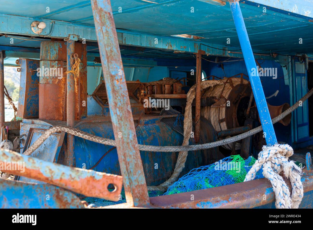 The covered deck of an old abandoned trawler in the marina at Roccella ...