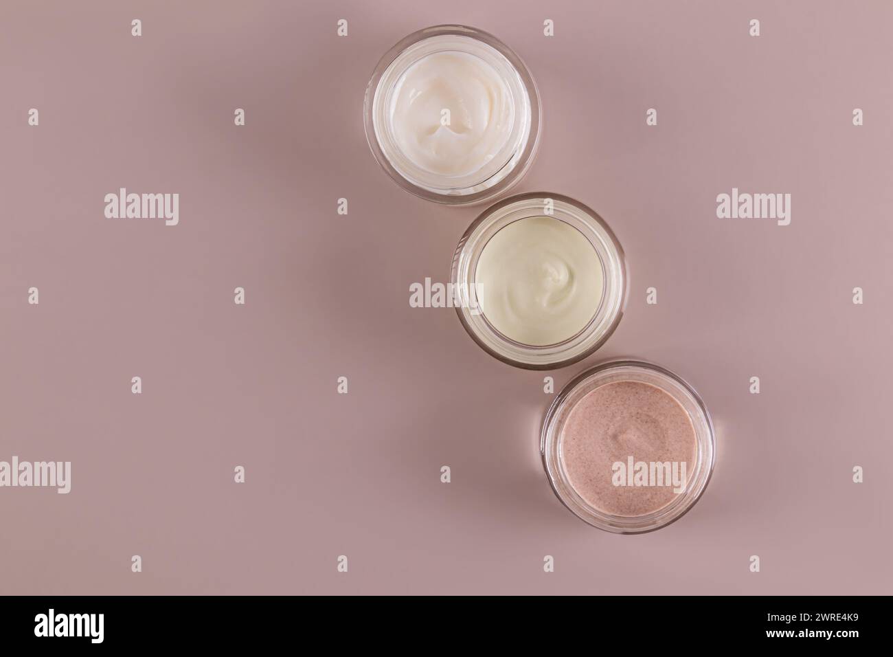 A jars with cosmetic cream of different textures and colors for face ...